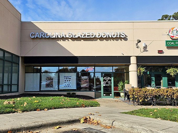 The unassuming storefront belies the magic within. Like finding a treasure map in your junk drawer, Carolina Glazed Donuts promises sweet adventures ahead.
