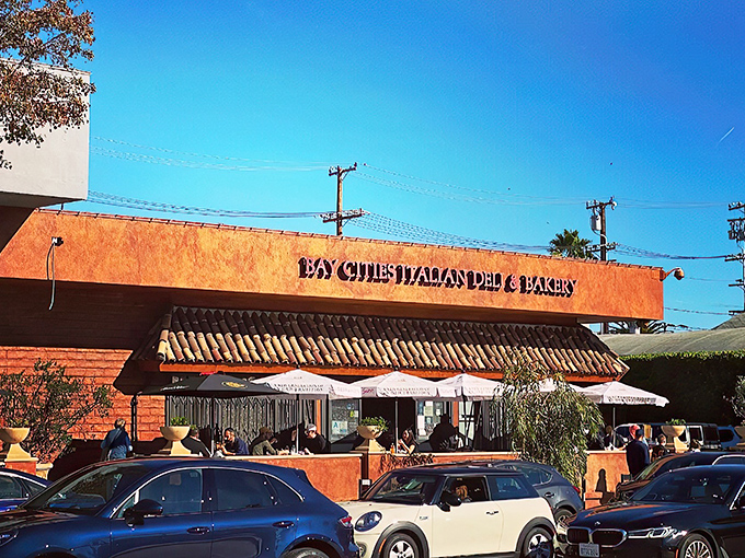 The unassuming terra-cotta exterior of Bay Cities hides culinary treasures within. Like finding a Lamborghini parked in a suburban garage—unexpected brilliance awaits.