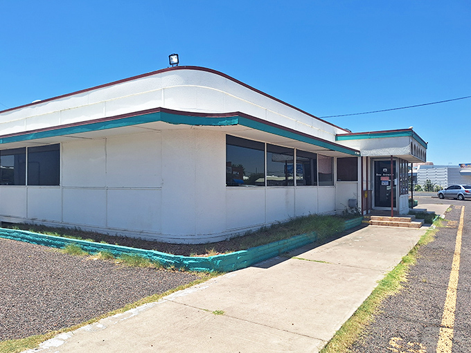 The unassuming exterior of Mel's Diner stands like a time capsule against the Arizona sky, promising comfort food treasures within its teal-trimmed walls.