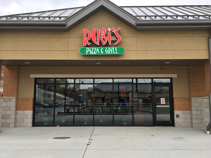Rubi's neon sign glows like a beacon for hungry travelers, promising Italian comfort food in this unassuming strip mall location. Pizza paradise awaits.