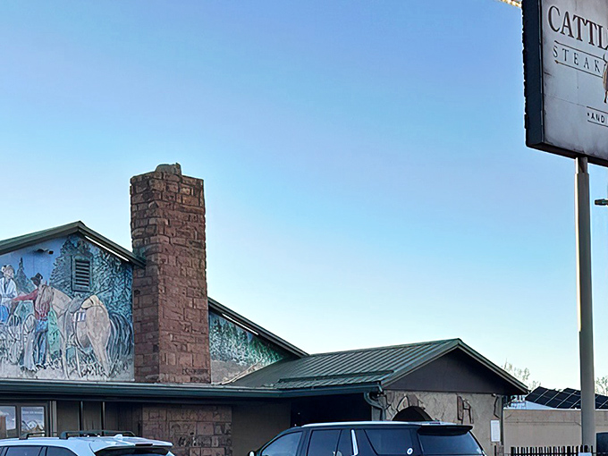The unassuming exterior of Cattlemen's Steakhouse & Lounge, where that stone chimney has witnessed countless Arizona sunsets and satisfied diners heading home with full bellies.