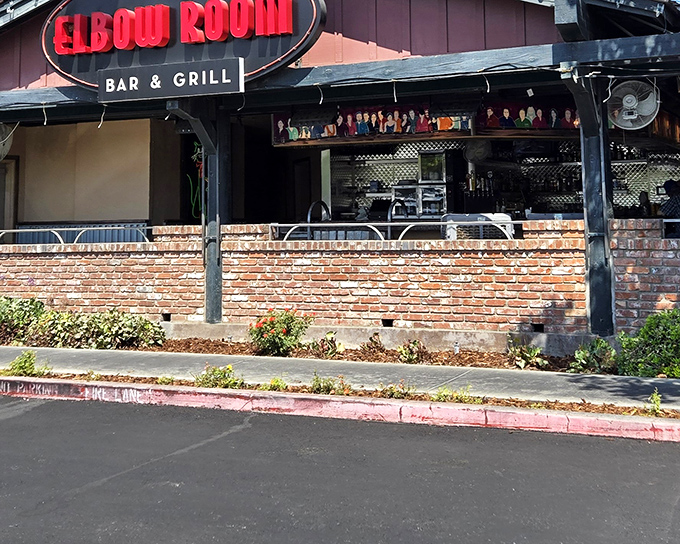 The iconic red neon sign beckons hungry travelers like a culinary lighthouse. Brick exterior and simple charm promise authentic flavors within.