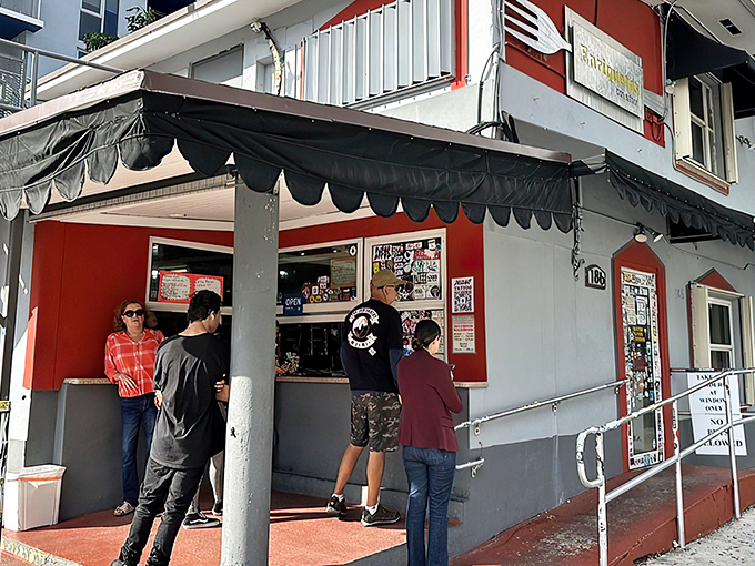 The unassuming exterior that hides culinary greatness. Like finding a Picasso at a yard sale, this red and white facade conceals Miami's sandwich paradise.