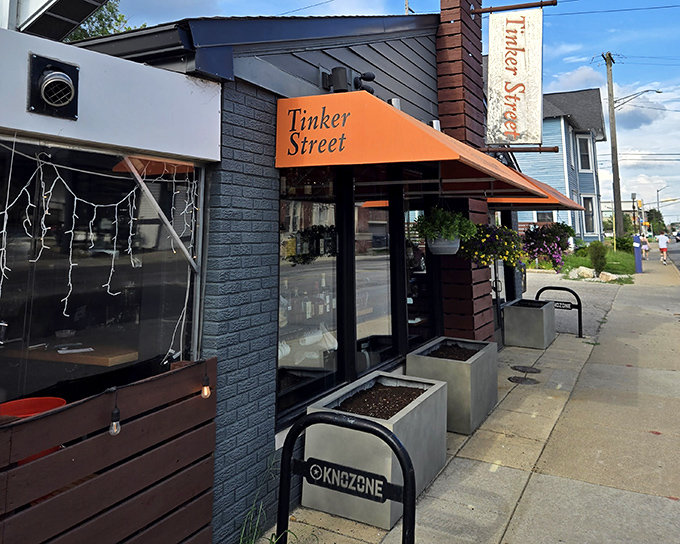 The bright orange awning of Tinker Street beckons like a culinary lighthouse on an unassuming Indianapolis corner. Prepare to be surprised.