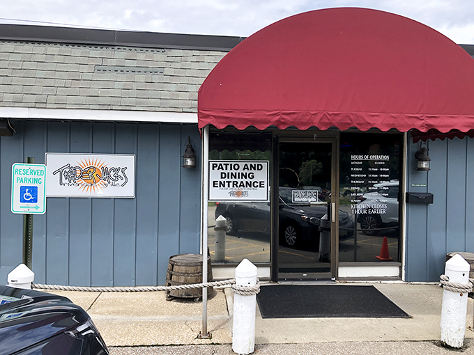 The unassuming blue exterior with its cheerful red awning is like that friend who doesn't brag but always delivers. Culinary treasures await inside!