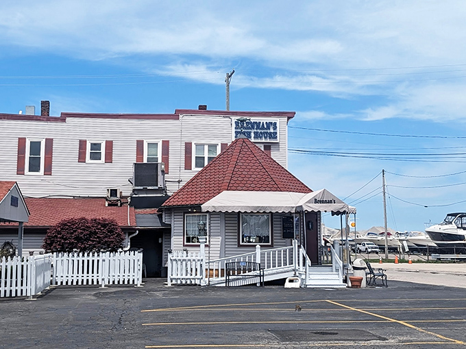 The unassuming exterior of Brennan's Fish House stands like a maritime mirage in Grand River, complete with charming white picket fence and distinctive red roof.