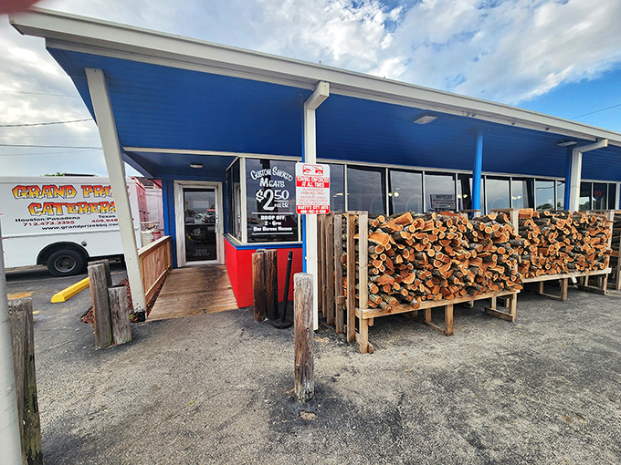 The entrance tells the whole story: serious wood for serious smoke. That stack isn't for show&mdash;it's tomorrow's flavor in waiting.