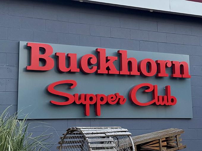 The iconic red lettering against gray concrete promises what every Wisconsinite knows: supper club magic awaits inside.