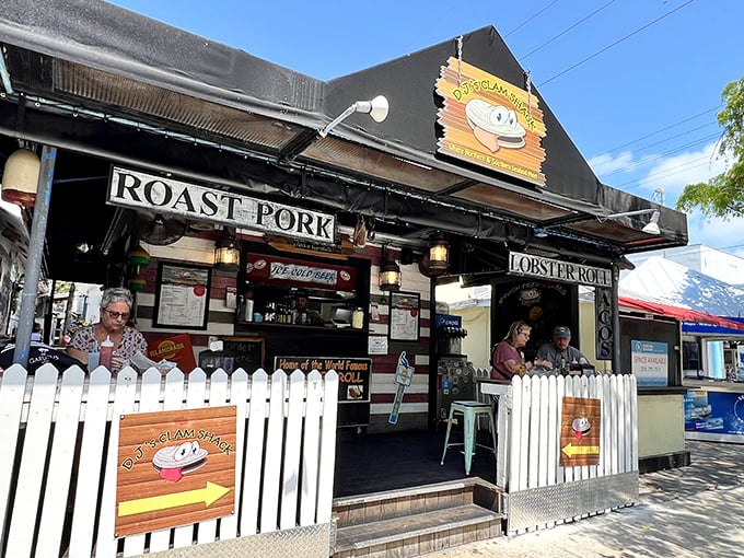 The white picket fence isn't keeping anyone out—it's corralling hungry seafood lovers into this unassuming Key West treasure that's become a culinary landmark.