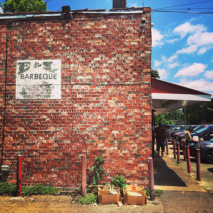 That weathered brick exterior isn't a marketing gimmick&mdash;it's a smoke-stained badge of honor earned through decades of barbecue excellence on Bailey Avenue.
