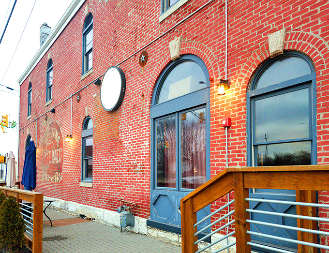 Another angle of Geraldine's distinctive exterior, where the weathered brick and blue accents create an inviting entrance to this Fountain Square gem.