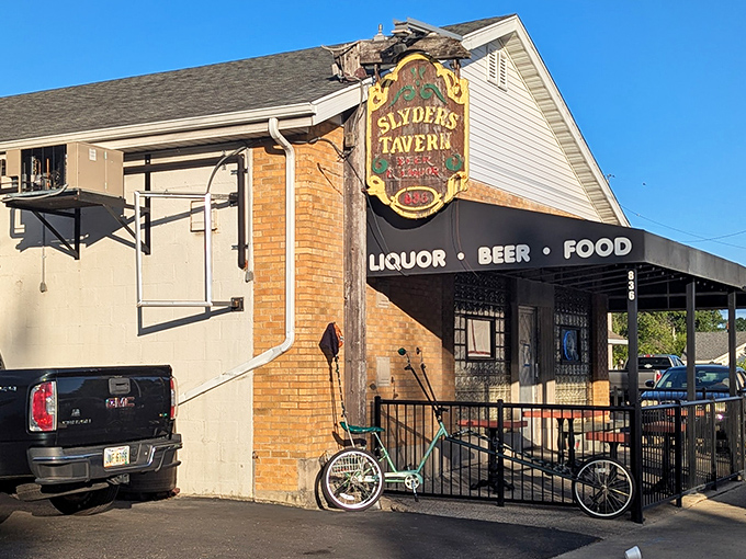 The unassuming exterior of Slyder's Tavern stands as a beacon to burger lovers, its vintage sign promising simple pleasures: liquor, beer, and unforgettable food.