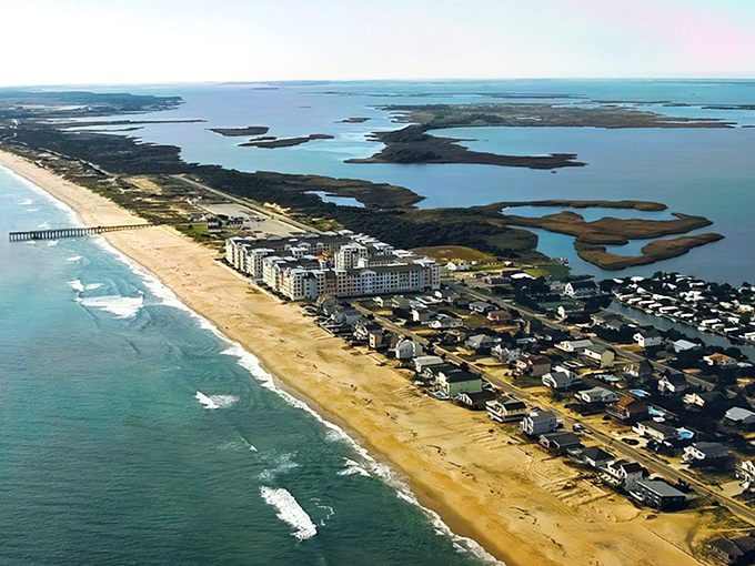 From above, Sandbridge unfolds as the perfect balance of wild beauty and seaside living—Atlantic waves on one side, Back Bay’s calm waters on the other.