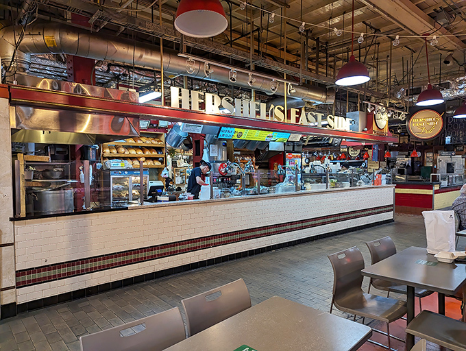 The iconic Hershel's storefront beckons hungry market-goers with its no-nonsense signage and promise of authentic deli delights.