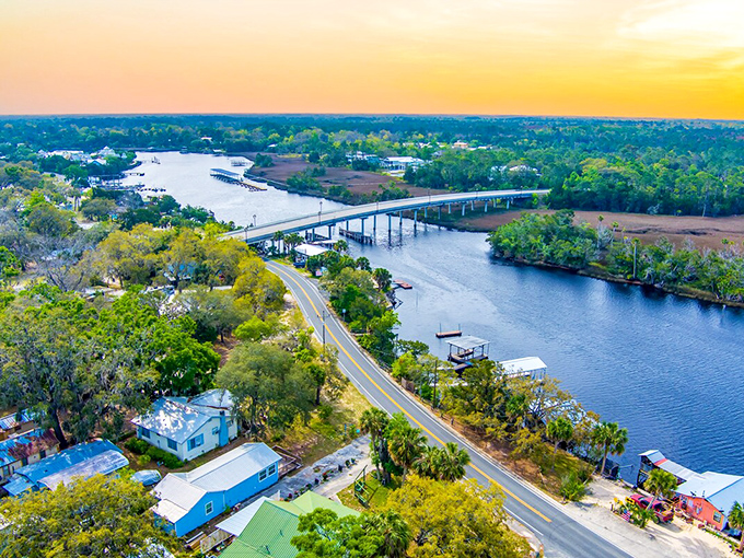 Sunset paints the Steinhatchee River bridge in golden hues, connecting not just shores but past and present in this timeless fishing village.
