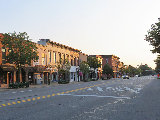 Downtown Tecumseh glows in golden hour light, its historic brick facades standing proud like sentinels of small-town charm that time forgot.