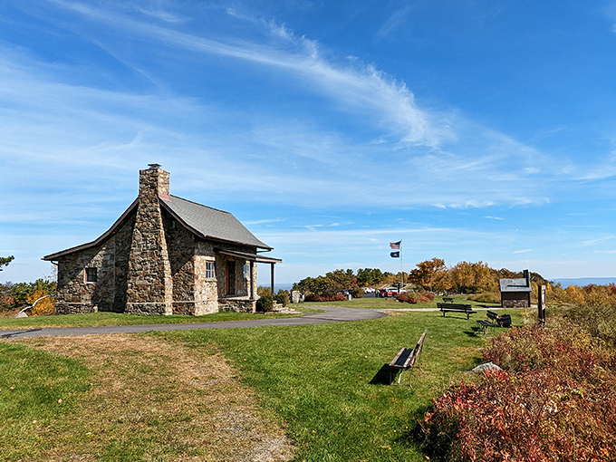 That historic stone cabin stands sentinel at the summit, a rugged timekeeper watching over three states' worth of breathtaking panoramas.