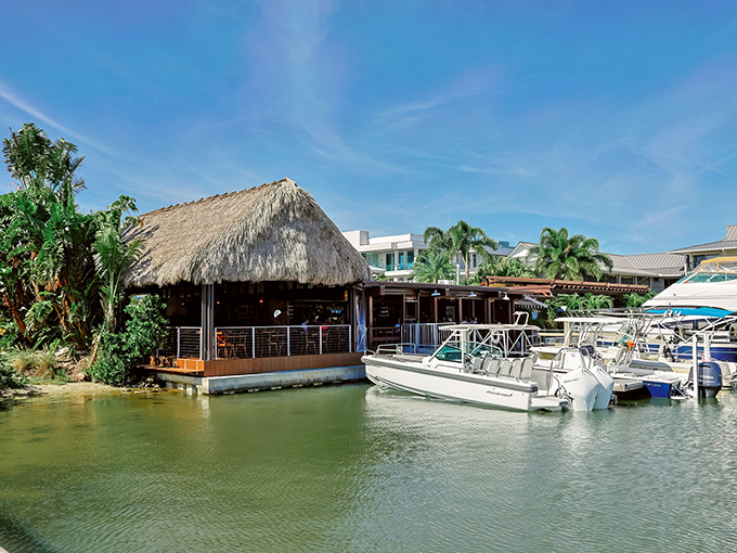 Paradise found! The thatched-roof charm of The Dock at Crayton Cove beckons boaters and landlubbers alike to this waterfront Naples treasure.