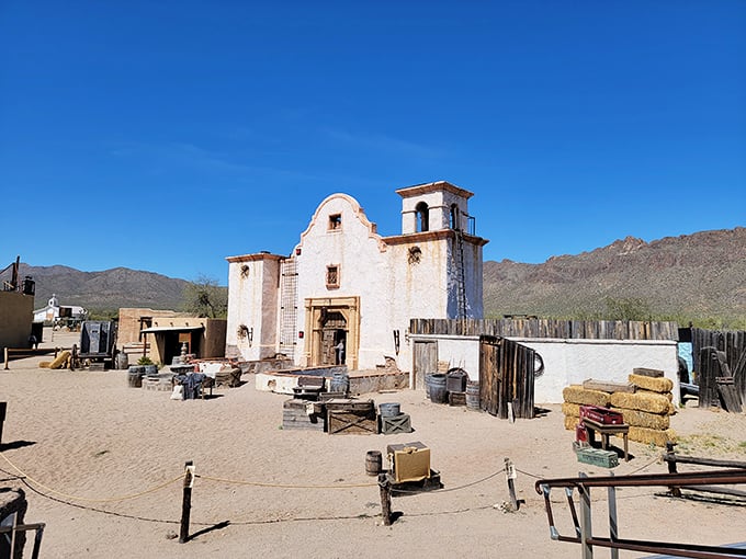 The mission-style church stands like a sentinel against the Tucson Mountains, its whitewashed walls practically glowing in the desert sun.