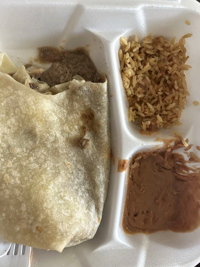 The holy trinity of Southwestern comfort: a perfect burrito, fluffy rice, and beans that didn't come from any can. A meal that feels like a warm hug.