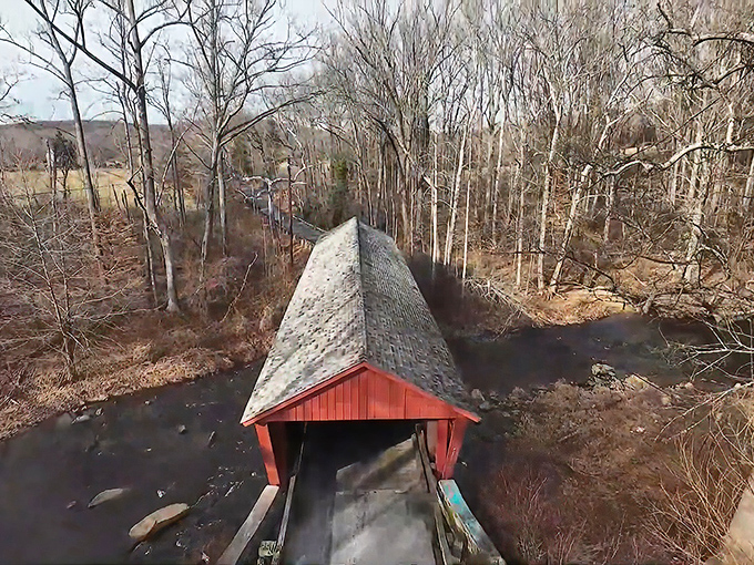 A bird's-eye view reveals how perfectly the bridge nestles into the Maryland countryside, like a crimson bookmark in nature's novel.