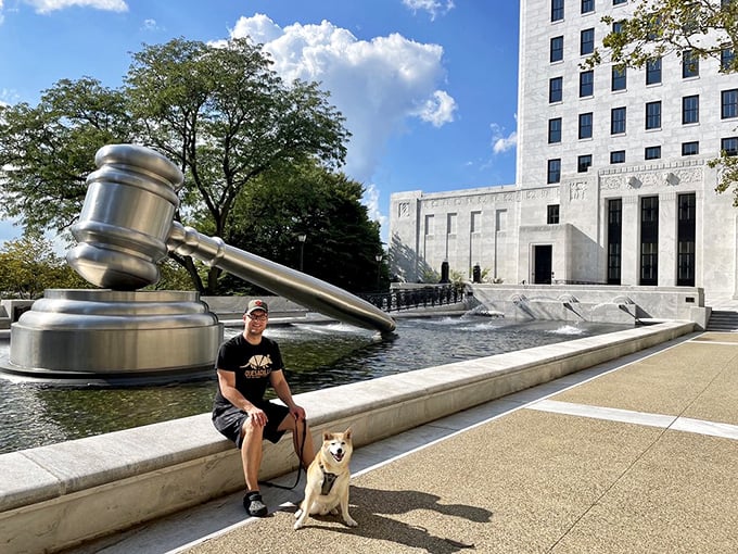 Man's best friend seems unimpressed by legal landmarks, but human visitors can't help but smile at this oversized symbol of courtroom drama.