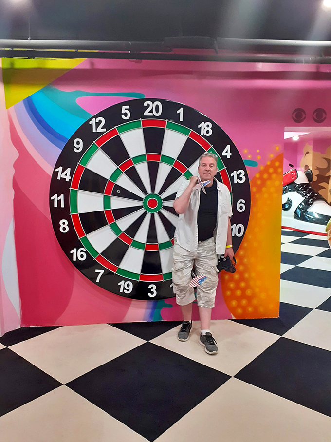 Standing tiny on a giant dartboard, because regular darts wasn't challenging enough for your competitive friends apparently.