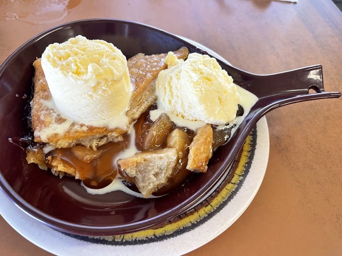 Apple cobbler with ice cream melting into warm crevices &ndash; dessert that makes you consider ordering breakfast for dinner just to justify it.