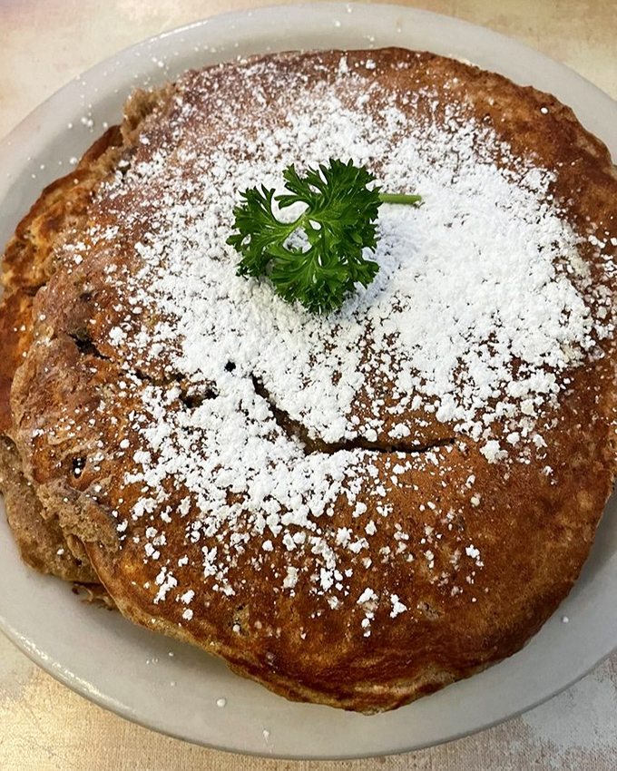 This pancake, dusted with powdered sugar and adorned with parsley, somehow manages to be both homey and elegant at the same time.