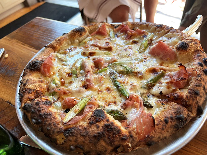 Prosciutto and asparagus pizza where the char on the crust plays perfect counterpoint to the delicate toppings&mdash;a study in delicious contrasts.