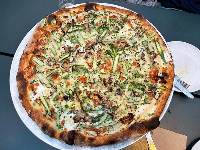 The asparagus pizza demonstrates that vegetables deserve their moment in the wood-fired spotlight too&mdash;a springtime symphony on dough.