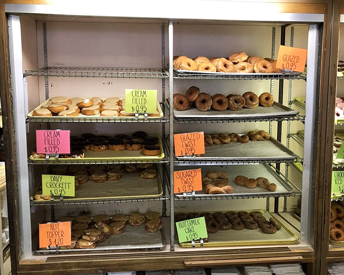 The display case&mdash;organized like a museum of deliciousness where each shelf tells a different chapter in the story of "why pants need elastic waistbands."
