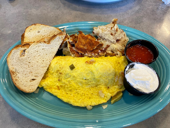 An omelet that's practically bursting with fillings, served with toast and sides. Breakfast architecture that somehow manages to be both impressive and comforting.
