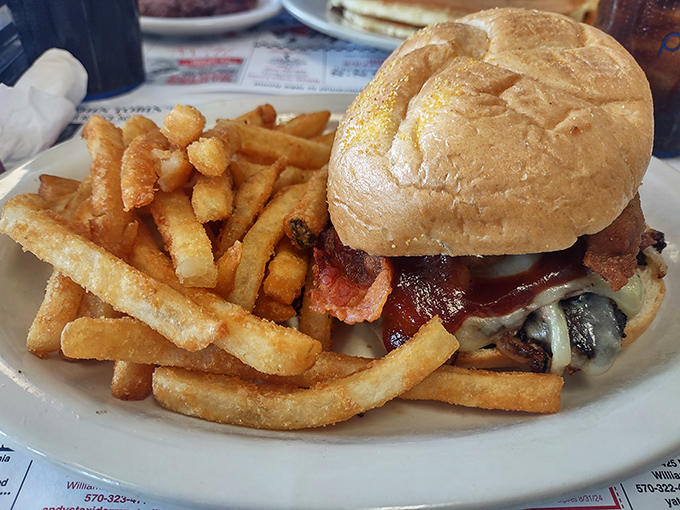 A burger that requires both hands, a stack of napkins, and possibly a signed waiver. Worth every messy, glorious bite.