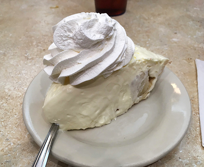 Banana cream pie wearing a cloud of whipped cream&mdash;proof that sometimes the most unforgettable desserts come on ordinary white plates.