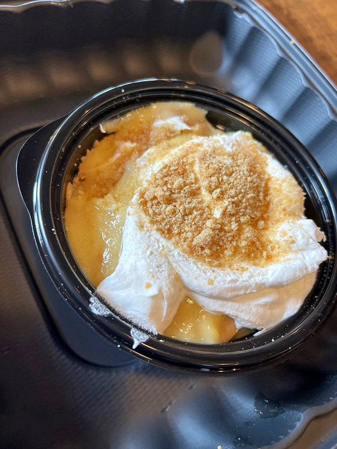 Banana pudding topped with a cloud of whipped cream. The kind of dessert that makes you consider licking the container in public.