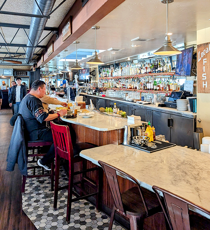 The marble-topped bar isn't just serving drinks&mdash;it's serving community, conversation, and coastal vibes by the glassful.