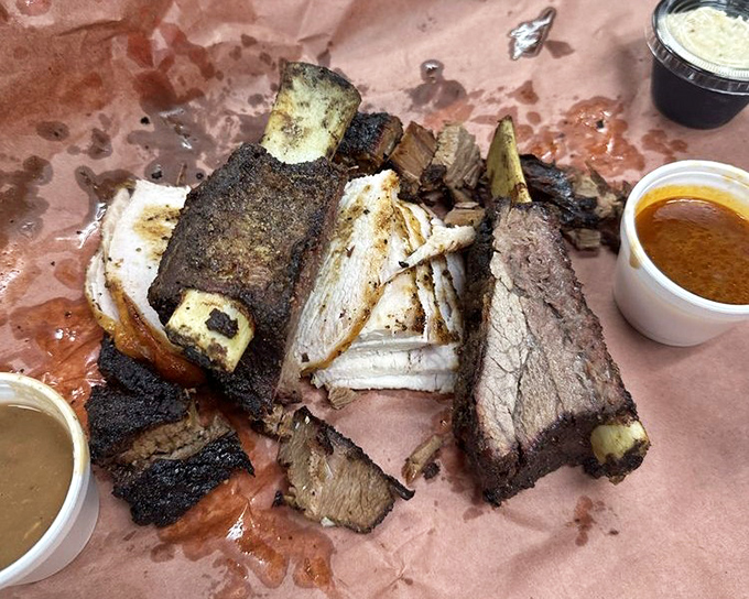 Beef ribs so massive they look like they came from prehistoric cattle. Fred Flintstone would approve of this car-tipping portion.