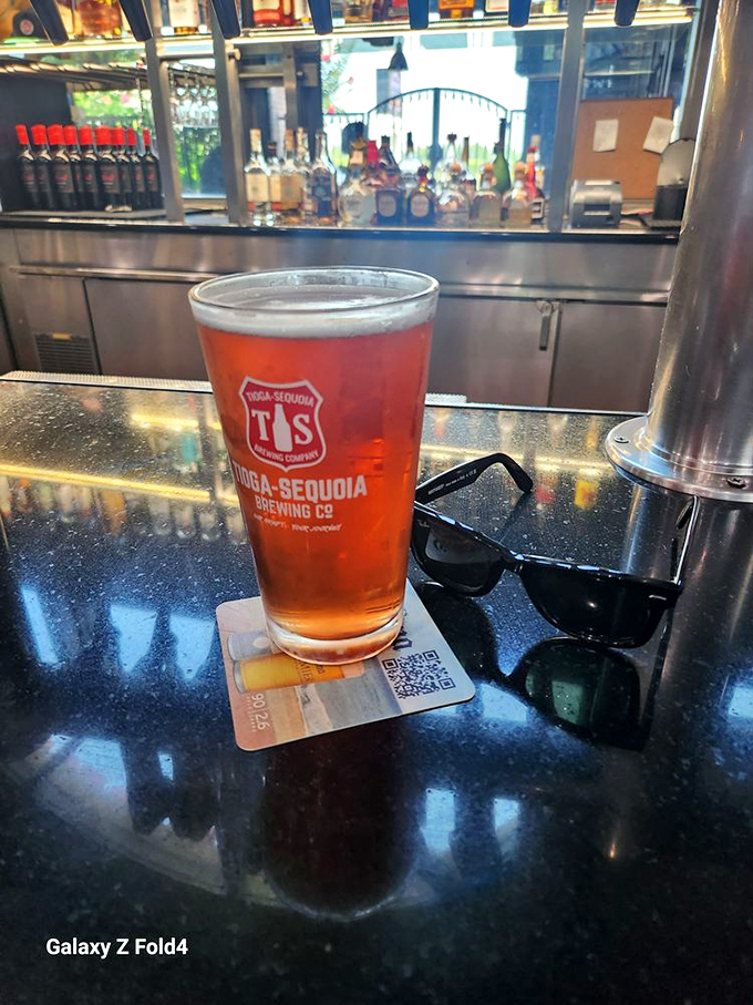 A local Tioga-Sequoia brew catches the light at the bar, offering liquid refreshment that pairs perfectly with smoky barbecue flavors.