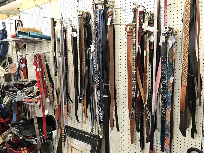 The belt section: where leather strips that once held up someone else's pants now await their second act in your wardrobe rotation.