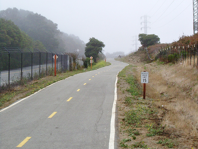 Fog-kissed pathways invite cyclists to experience the mountain at a pace slow enough to notice every detail of its changing moods.