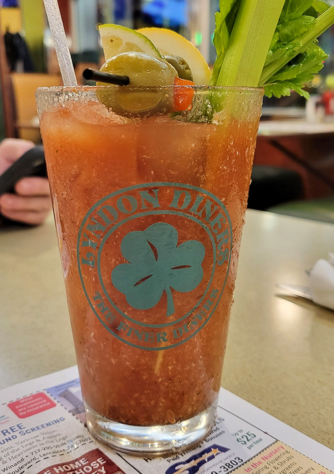 A Bloody Mary adorned like it's heading to a cocktail gala, complete with the diner's signature clover logo. Breakfast of champions, indeed.