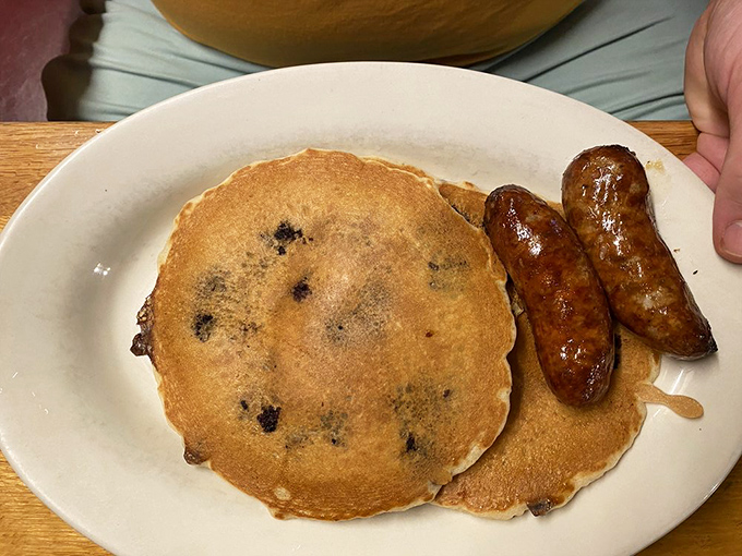 Blueberry pancakes that taste like summer mornings, paired with sausages that provide the perfect savory counterpoint. Breakfast of champions!
