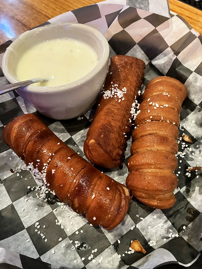 These pretzel breadsticks aren't just appetizers&mdash;they're dunkable vessels of joy waiting for their cheese sauce baptism.