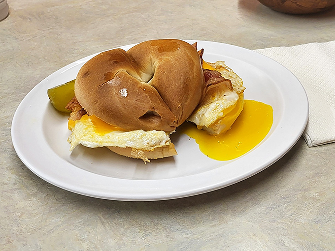 The breakfast sandwich that makes bagels feel special again. Egg yolk dripping down the side is nature's most perfect sauce.