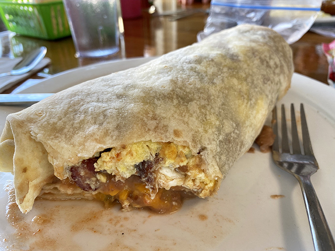 Breakfast burritos packed with eggs, beans, and cheese deliver portable satisfaction wrapped in flour tortilla perfection.