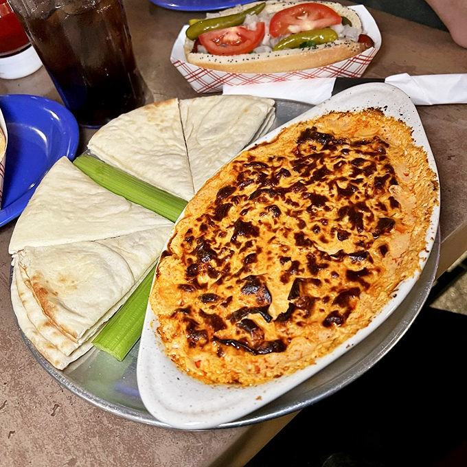 Buffalo chicken dip with warm pita triangles&mdash;the kind of appetizer that makes you consider canceling your entr&eacute;e and ordering three more of these.