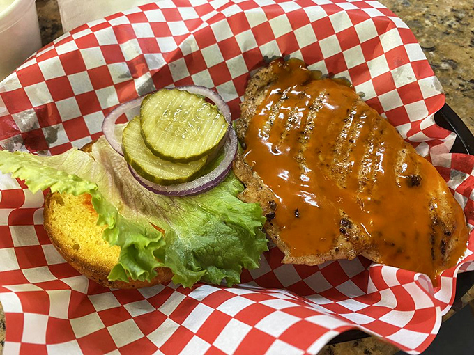 A masterclass in sandwich architecture: perfectly toasted bun, juicy chicken, and toppings arranged for optimal bite satisfaction.