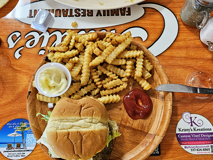 A burger and fries served on a wooden board&mdash;no pretentious slate plates here, just honest food that demands to be devoured.