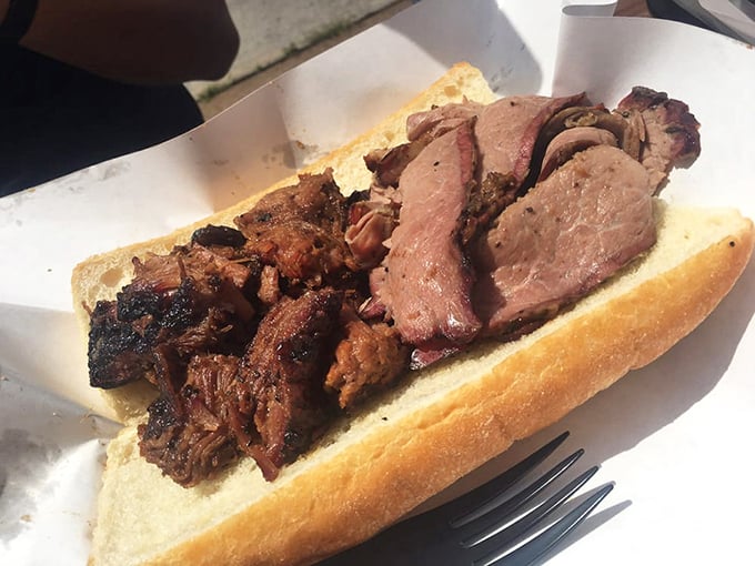 The holy trinity of BBQ: burnt ends and brisket on a sandwich with beans. Not all heroes wear capes&mdash;some come on paper plates.